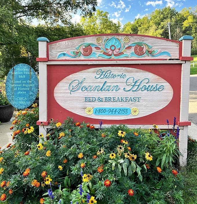 The welcoming sign, surrounded by cheerful blooms, announces your arrival at one of Minnesota's most cherished historical treasures.