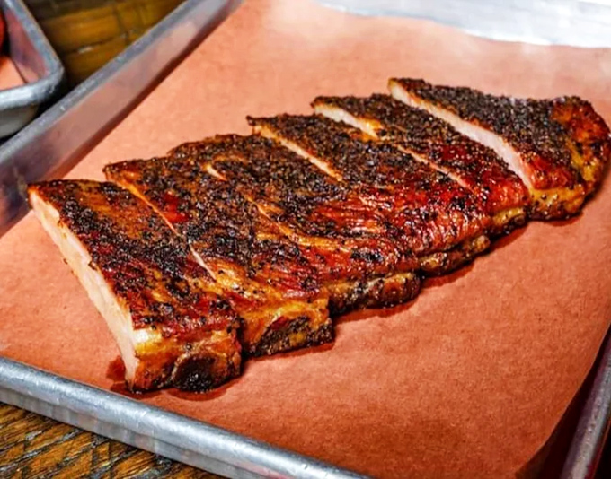 These ribs don't just fall off the bone – they practically leap into your mouth, leaving behind a trail of smoky, peppery perfection.