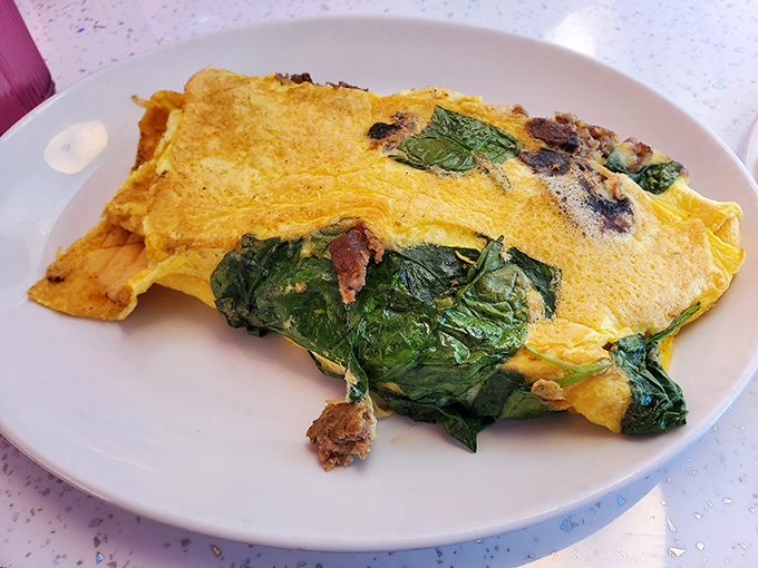 Spinach Omelet: A fluffy egg canvas painted with vibrant greens and savory fillings &ndash; proof that vegetables can absolutely belong at the breakfast table.