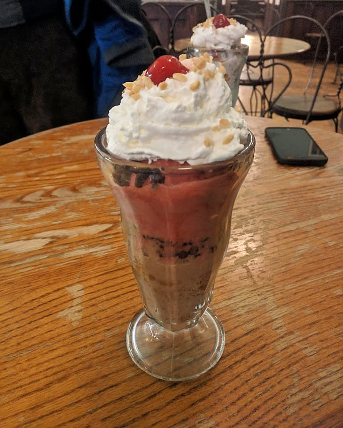 Layered parfait-style sundaes prove that ice cream can be both beautiful and delicious, like edible architecture with cherries on top.