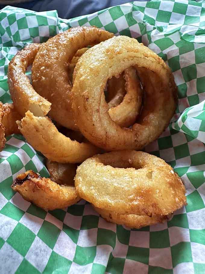 Golden onion rings that stay together from first bite to last, crispy outside and sweet inside, pure fried perfection in every circle.
