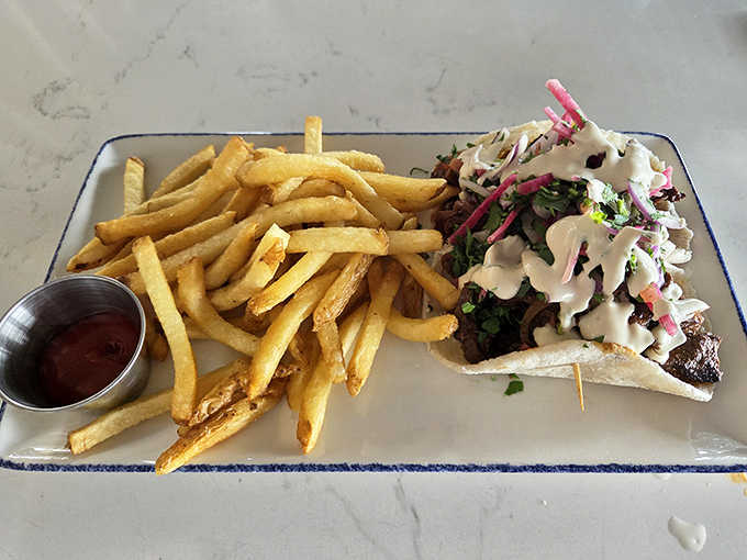 Golden fries and a perfectly assembled gyro create the ultimate comfort food pairing, proving The Foxtail excels at elevated casual fare too.