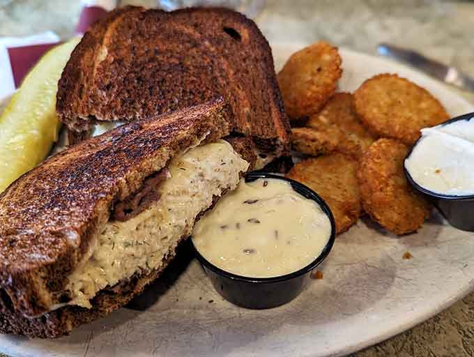 That Reuben sandwich is stacked high with corned beef, sauerkraut, and melted Swiss on perfectly toasted rye bread.