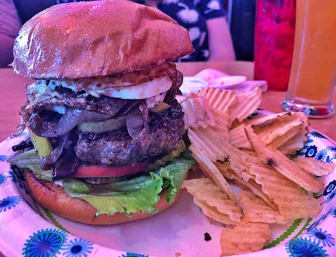 This burger stacks up like a delicious Jenga game where everyone wins, especially your taste buds and stomach.