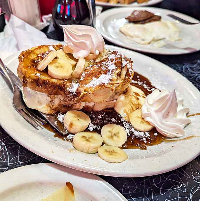 Stuffed French toast that makes ordinary breakfasts weep with inadequacy &ndash; bananas, cream, and syrup creating a morning symphony.