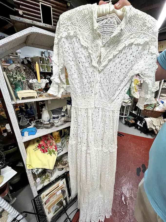 This delicate vintage dress isn't just clothing &ndash; it's a ghost of celebrations past, still holding the shape of someone's most special day.