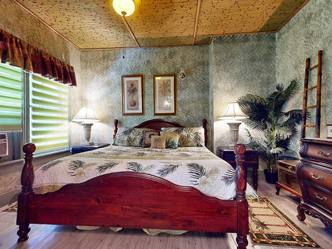Palm fronds dance across bedding in this tropical-themed sanctuary where you'll sleep so well, you'll suspect the pillows are medicated.