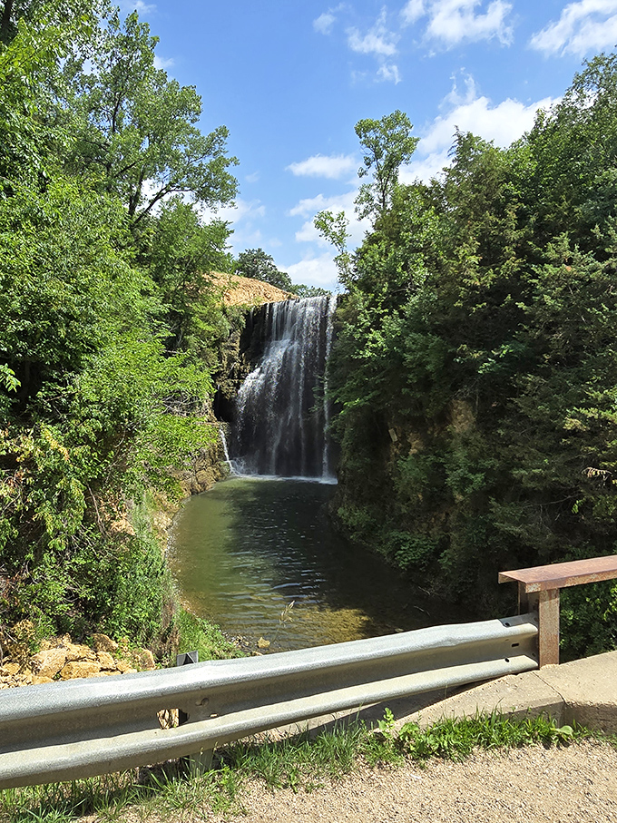 The viewing point offers a perfect frame for nature's masterpiece, where the waterfall's power and grace can be safely admired from a distance.