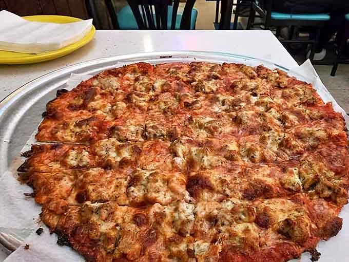 The sausage and green pepper pizza arrives with those signature square cuts &ndash; a Chicago tradition that sparks friendly debates over corner pieces.