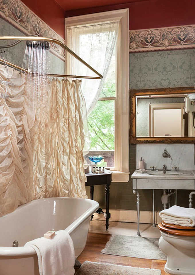 Victorian elegance meets modern plumbing in this bathroom where you'll want to linger longer than necessary, admiring vintage fixtures.