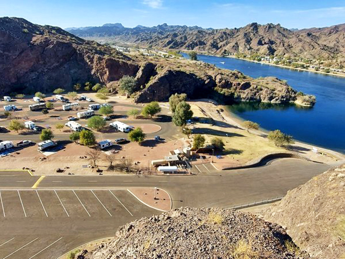 An aerial view reveals the park's layout, with campsites nestled between mountains and shoreline.