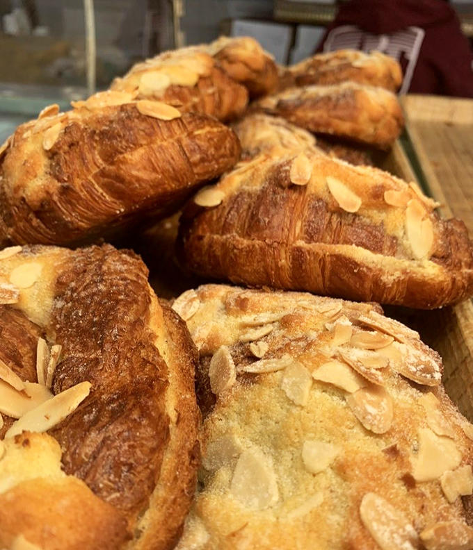 Almond croissants topped with sliced almonds and dusted with powdered sugar, because sometimes gilding the lily is absolutely the right choice.