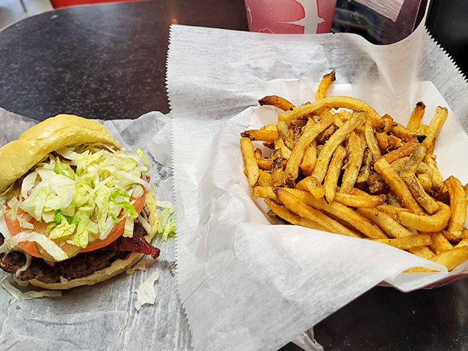 The bacon cheeseburger arrives like an edible work of art, with layers of flavor that make modern gourmet versions seem unnecessarily complicated.
