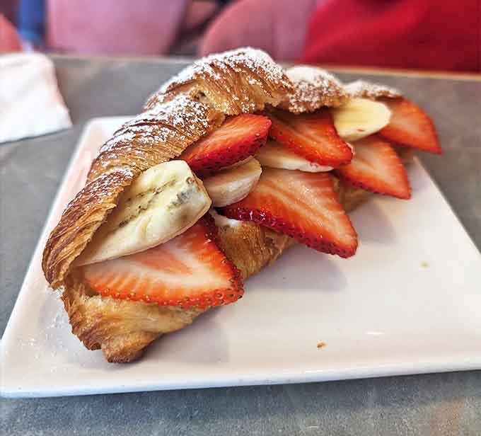 A symphony of textures and flavors awaits in this banana and strawberry croissant&mdash;crisp exterior giving way to fruit-filled bliss.