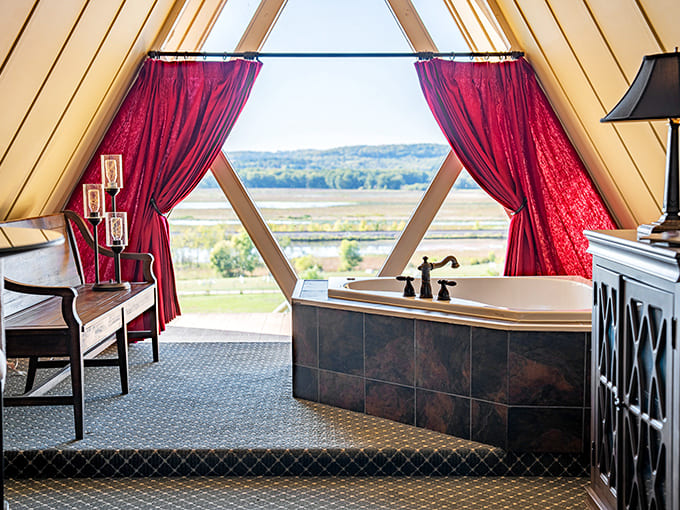 Dramatic triangular windows frame breathtaking valley views from this soaking tub &ndash; nature's own IMAX theater for the discerning bather.