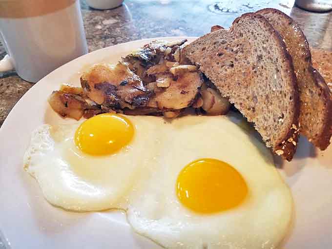 Sunny-side up eggs with perfectly saut&eacute;ed mushrooms and hearty wheat toast. A breakfast trinity that promises to start your day on the right note.