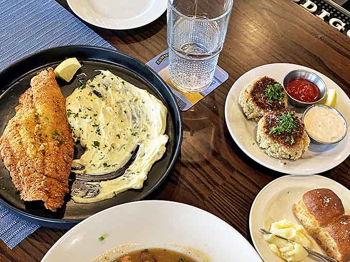 The ultimate Southern comfort plate&mdash;crispy catfish meets creamy grits while those famous crab cakes make you question why you'd ever order anything else.