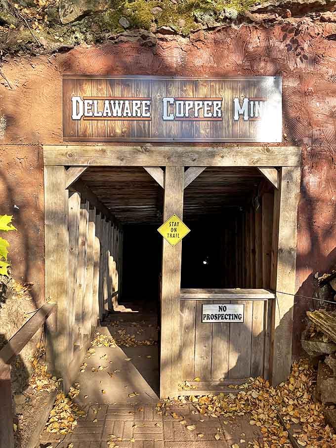 The timber-framed portal beckons adventurers into the earth, promising cool air and a glimpse into America's industrial revolution.