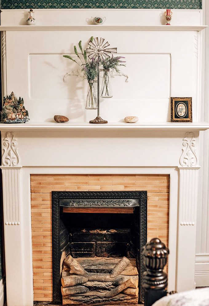 This elegant fireplace mantel showcases the Victorian love of symmetry and natural elements, creating a focal point that draws the eye.