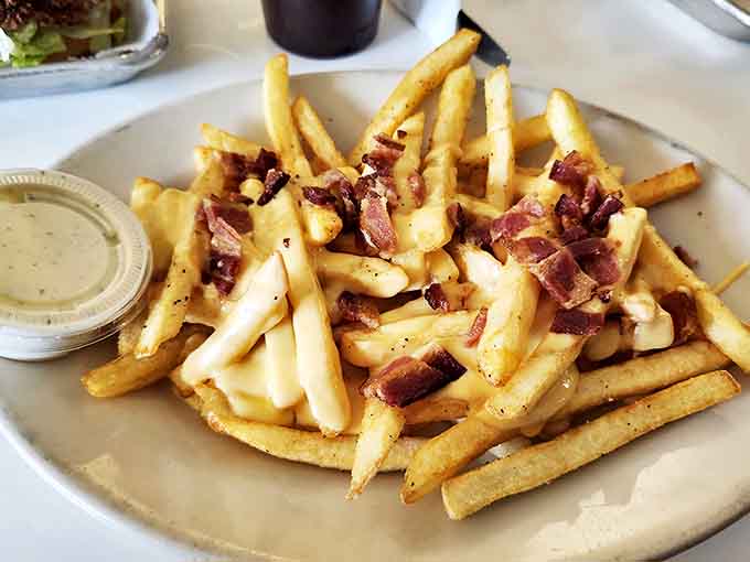 Golden fries topped with bacon because sometimes you need to remind yourself that life is worth living.