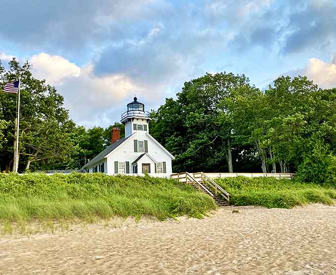 From the beach, the lighthouse appears as a postcard come to life, its white facade gleaming against the backdrop of Michigan's blue skies.