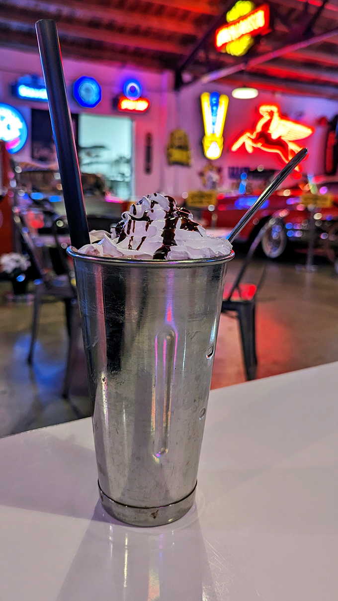 A mountain of whipped cream crowns this metal milkshake vessel, promising brain freeze that's entirely worth the temporary discomfort.