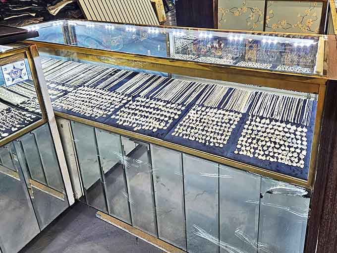 Treasure gleams under glass as necklaces, rings, and bracelets await their next chapter, each piece holding stories of celebrations past and future.