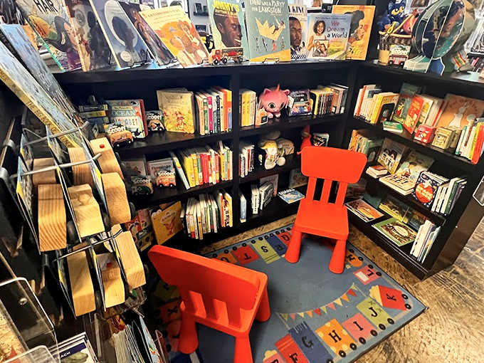 The children's section, with its bright red chairs and low shelves, understands that young readers need their own space to discover stories that might become lifelong friends.
