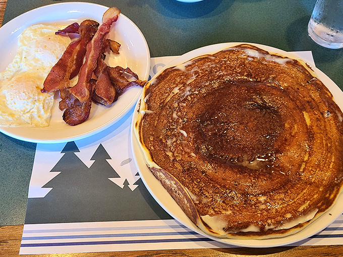 Morning sunshine on a plate &ndash; these pancakes extend beyond their earthly boundaries while eggs and bacon huddle nearby for moral support. 