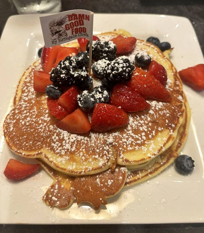 Breakfast perfection doesn't get better than this: fluffy pancakes crowned with berries and a little flag that proudly announces "Damn Good Food."