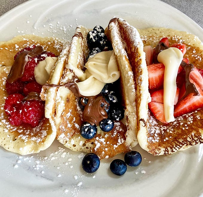 Fruit and pancake harmony &ndash; fresh berries and decadent toppings transform breakfast into a colorful celebration that's almost too pretty to eat. Almost.