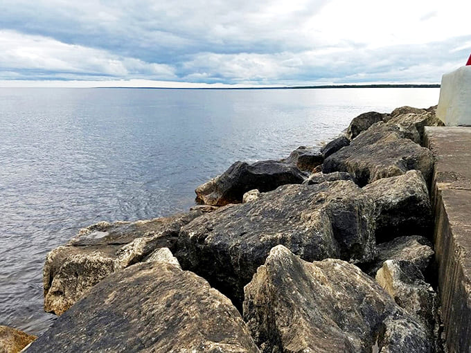 Lake Michigan's rocky shoreline tells geological stories spanning millennia, where each stone has been tumbled to perfection by persistent waves.