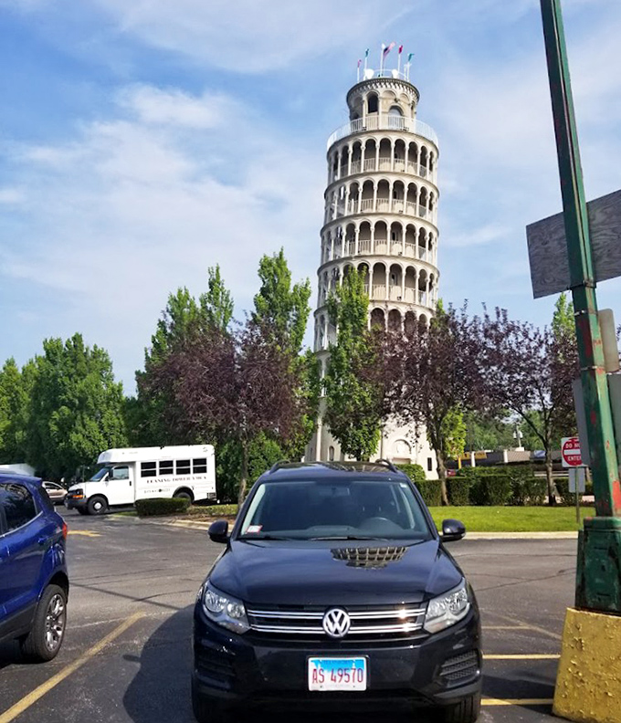 From the parking lot perspective, the tower rises unexpectedly among everyday suburban surroundings, creating a delightful visual surprise for visitors.