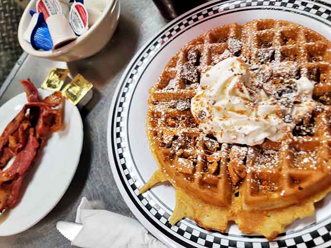 Golden waffle perfection meets crispy bacon &ndash; the breakfast equivalent of Fred Astaire and Ginger Rogers dancing across your taste buds.