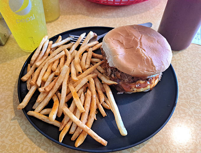 The classic combo that's launched a thousand road trips: a BBQ sandwich that demands to be savored alongside fries that refuse to be ignored.