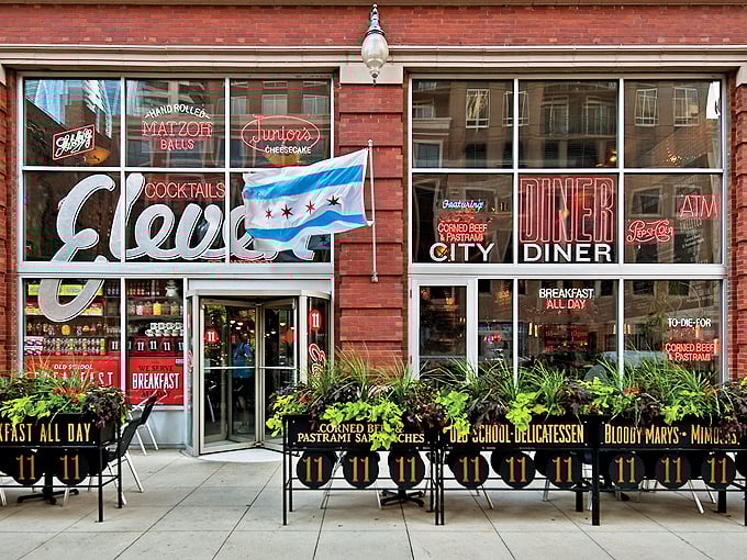 Eleven City Diner's brick facade and Chicago flag proudly announce its blend of city sophistication and classic diner comfort.