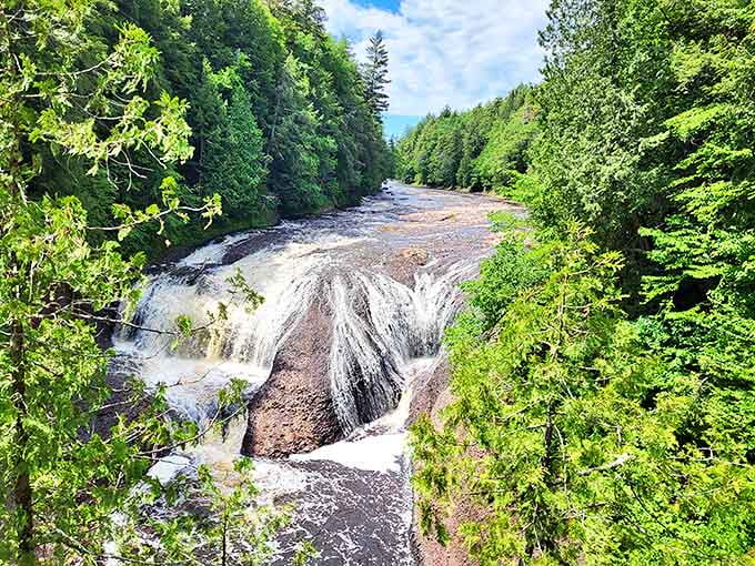 Potawatomi Falls rushes through a rocky gorge, creating a powerful display that echoes through the forest.