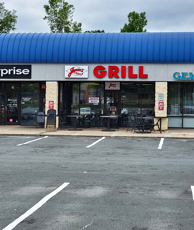 The inviting storefront of Junior's Cafe & Grill promises comfort food classics and friendly service behind its glass doors.