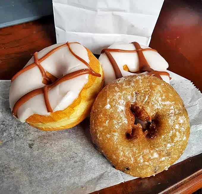 White icing drizzled with caramel creates edible art. These aren't just donuts; they're the reason elastic waistbands were invented.