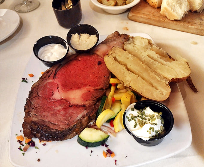 A carnivore's dream that barely needs a knife, accompanied by a loaded baked potato that's practically a meal itself..