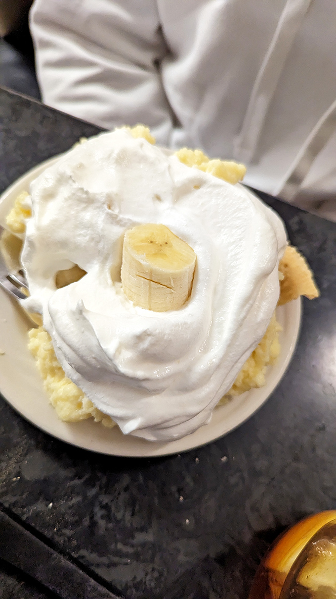 This banana cream pie doesn't just have layers of flavor &ndash; it has architectural integrity that would impress engineers, crowned with a perfect banana centerpiece.