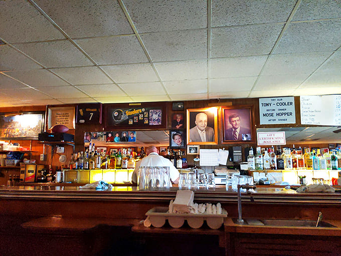 Where stories flow as freely as the drinks. The amber backlit bottles create that perfect glow that makes everyone look like they're starring in their own movie.