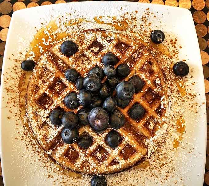 Plump blueberries nestled in golden squares, dusted with powdered sugar like the first perfect snowfall of winter.