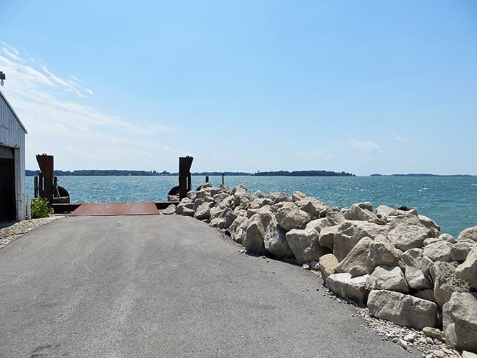 Shoreline view with rocky edge: Where land meets water in a rugged embrace – North Bass Island's untamed shoreline offers front-row sunset seats.