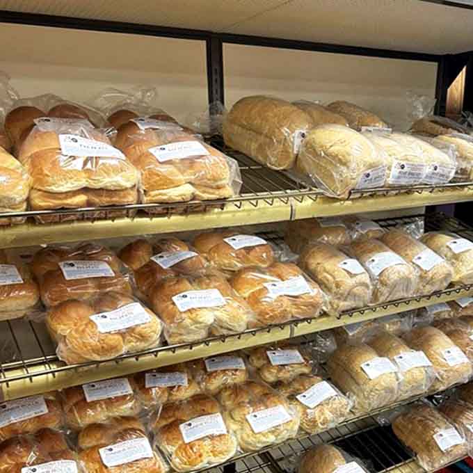 Fresh-baked bread lined up like soldiers ready for duty—each loaf promising sandwiches that will ruin store-bought bread for you forever.