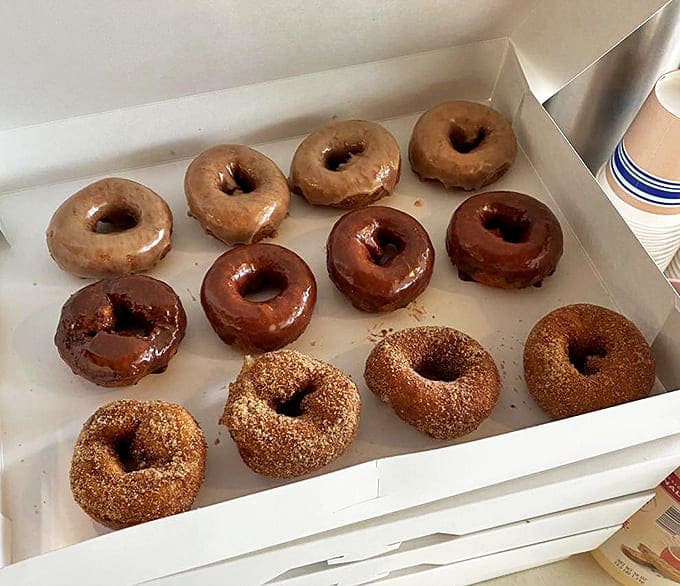 A box of happiness to go! These assorted donuts won't survive the car ride home &ndash; the ultimate souvenir that disappears faster than you can say "just one more."