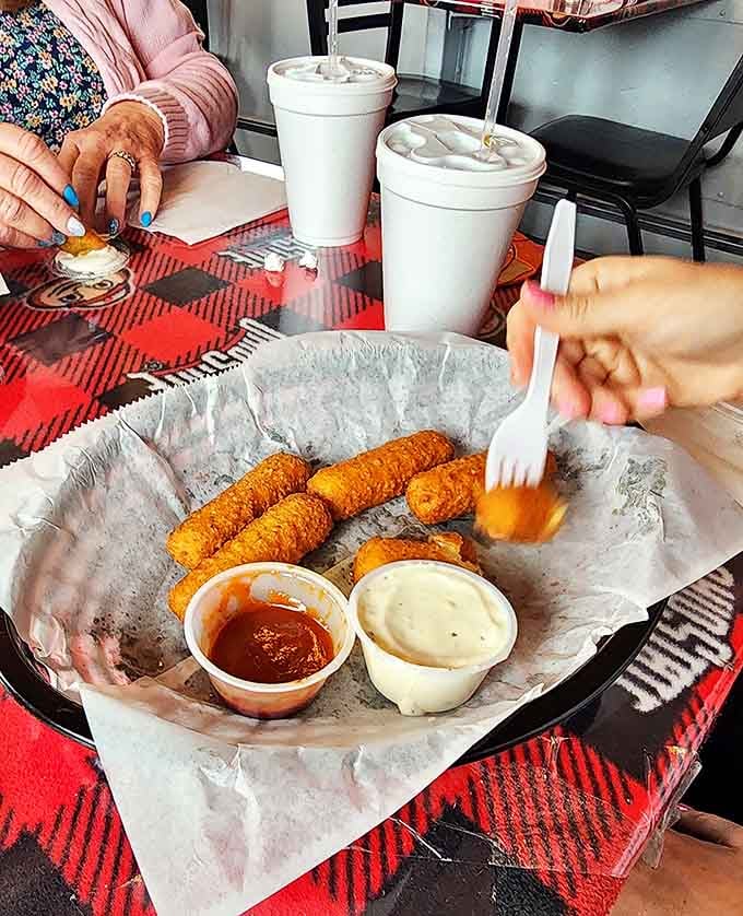 Golden-fried mozzarella sticks with that perfect cheese pull &ndash; the universal language of comfort food spoken fluently here.
