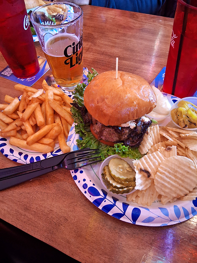 Burger and Beer: The quintessential Turf Club experience&mdash;a towering burger with all the fixings alongside golden fries and a cold draft beer.
