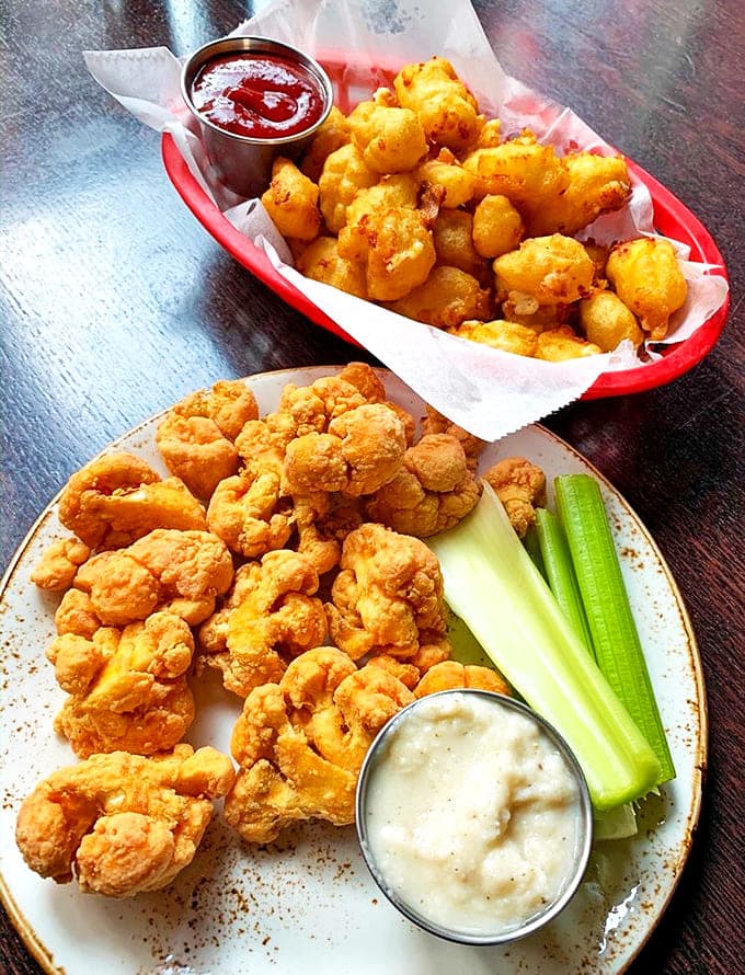 A feast for the eyes and stomach: crispy buffalo cauliflower shares the spotlight with those legendary cheese curds.