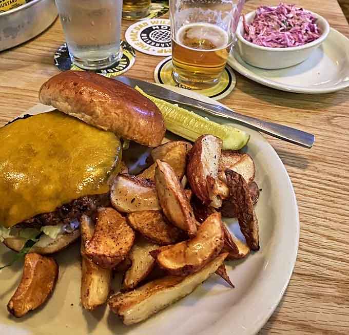 Behold the cheeseburger in all its glory! That vibrant slaw and those golden potatoes are the backup singers to the beef's lead performance.